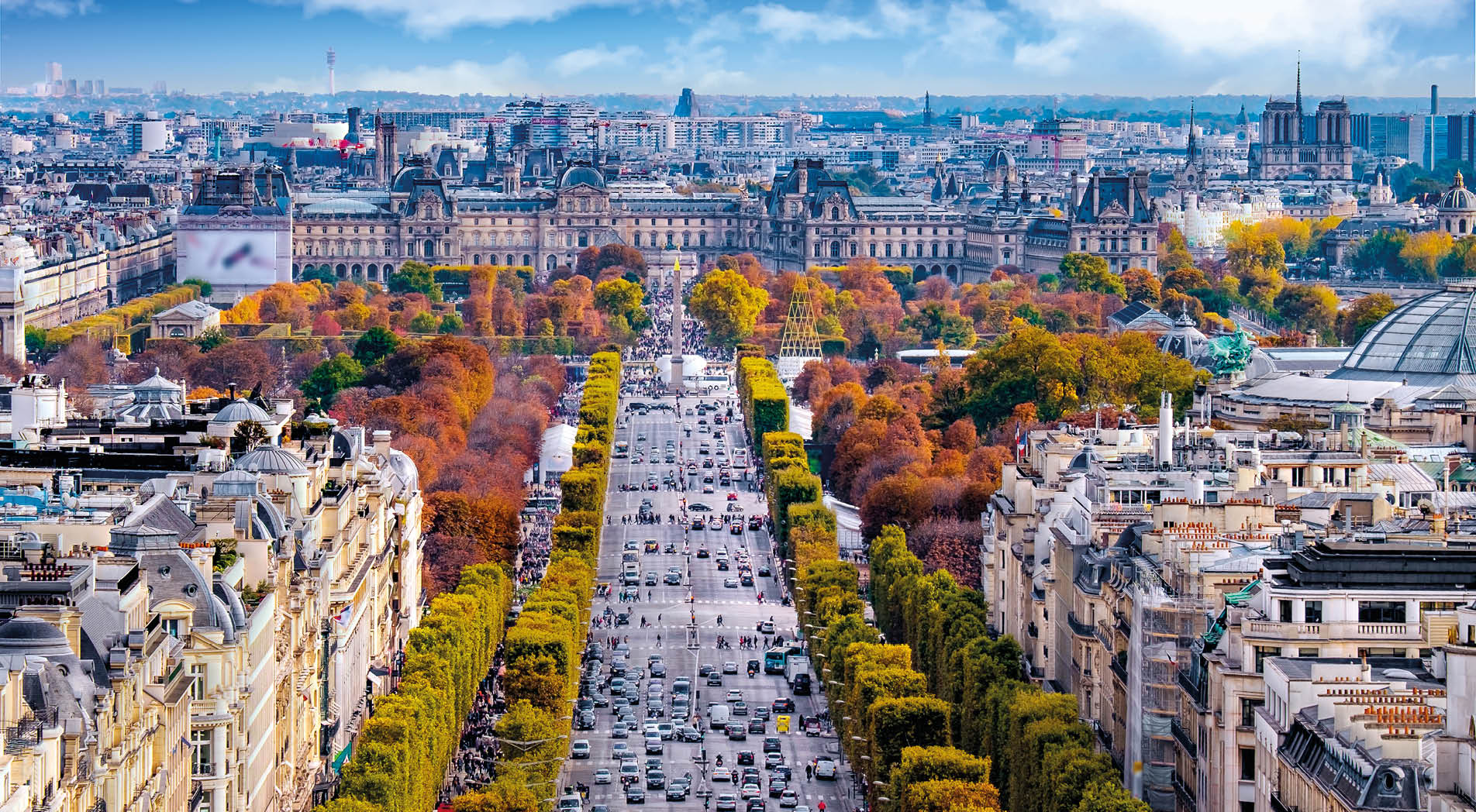 The Avenue des Champs- lys es in late autumn seen from the Arc de Triomphe. Orange and yellow ...