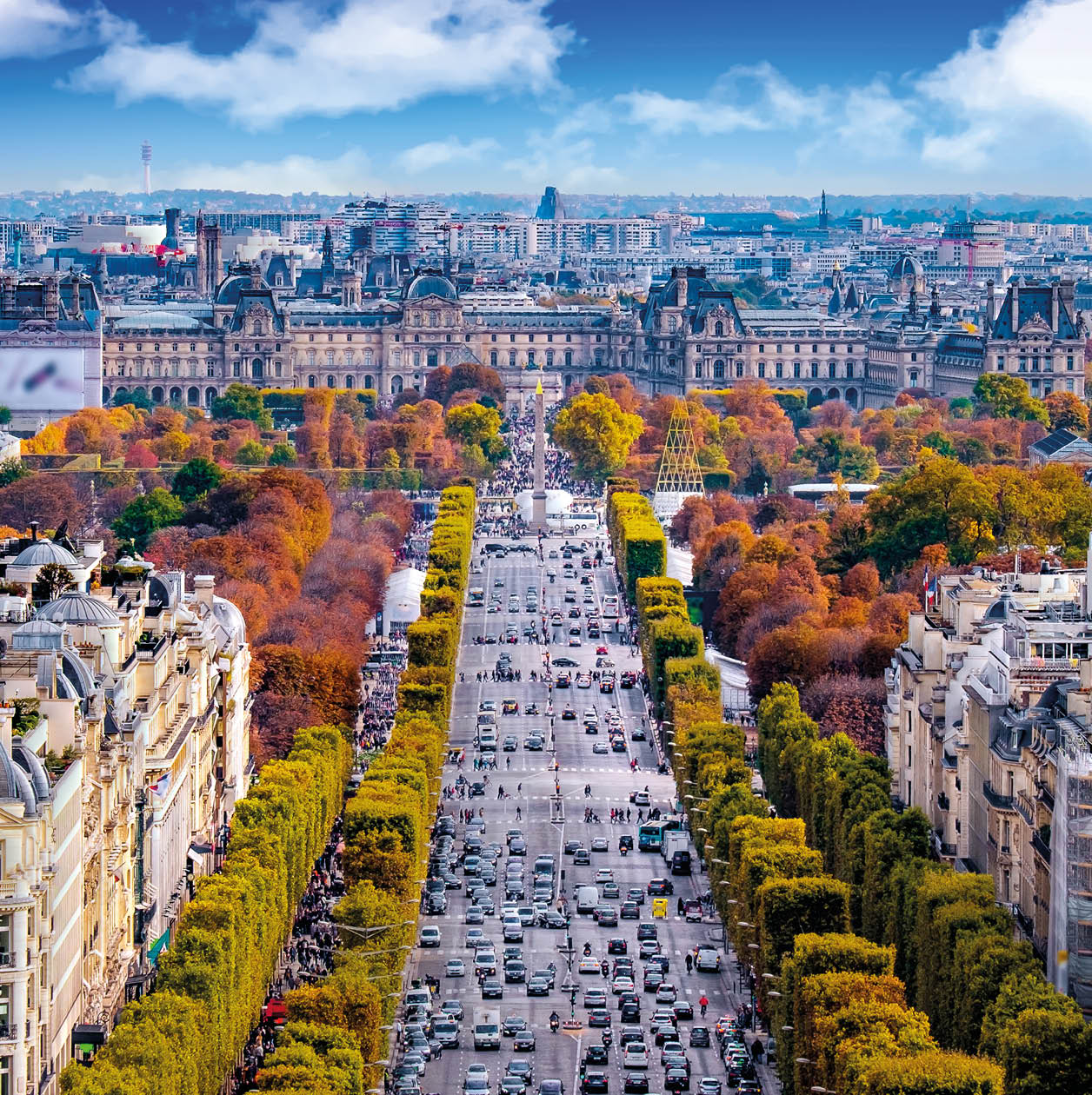 The Avenue des Champs- lys es in late autumn seen from the Arc de Triomphe. Orange and yellow ...